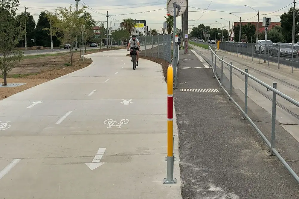 What is the purpose of bicycle holding rails I see on the road side?